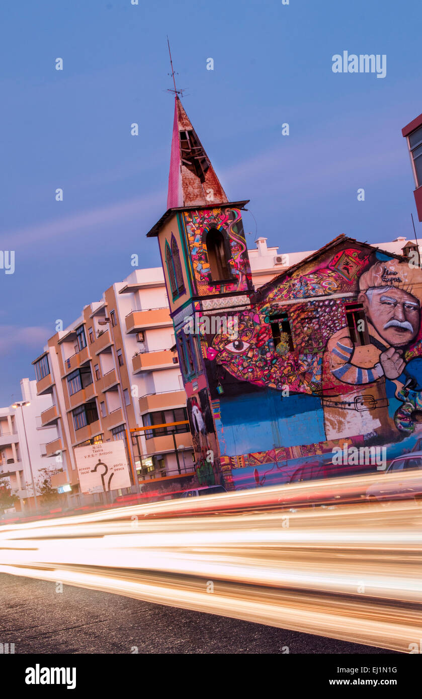 View of a fully covered graffiti on a building next to a road with ...
