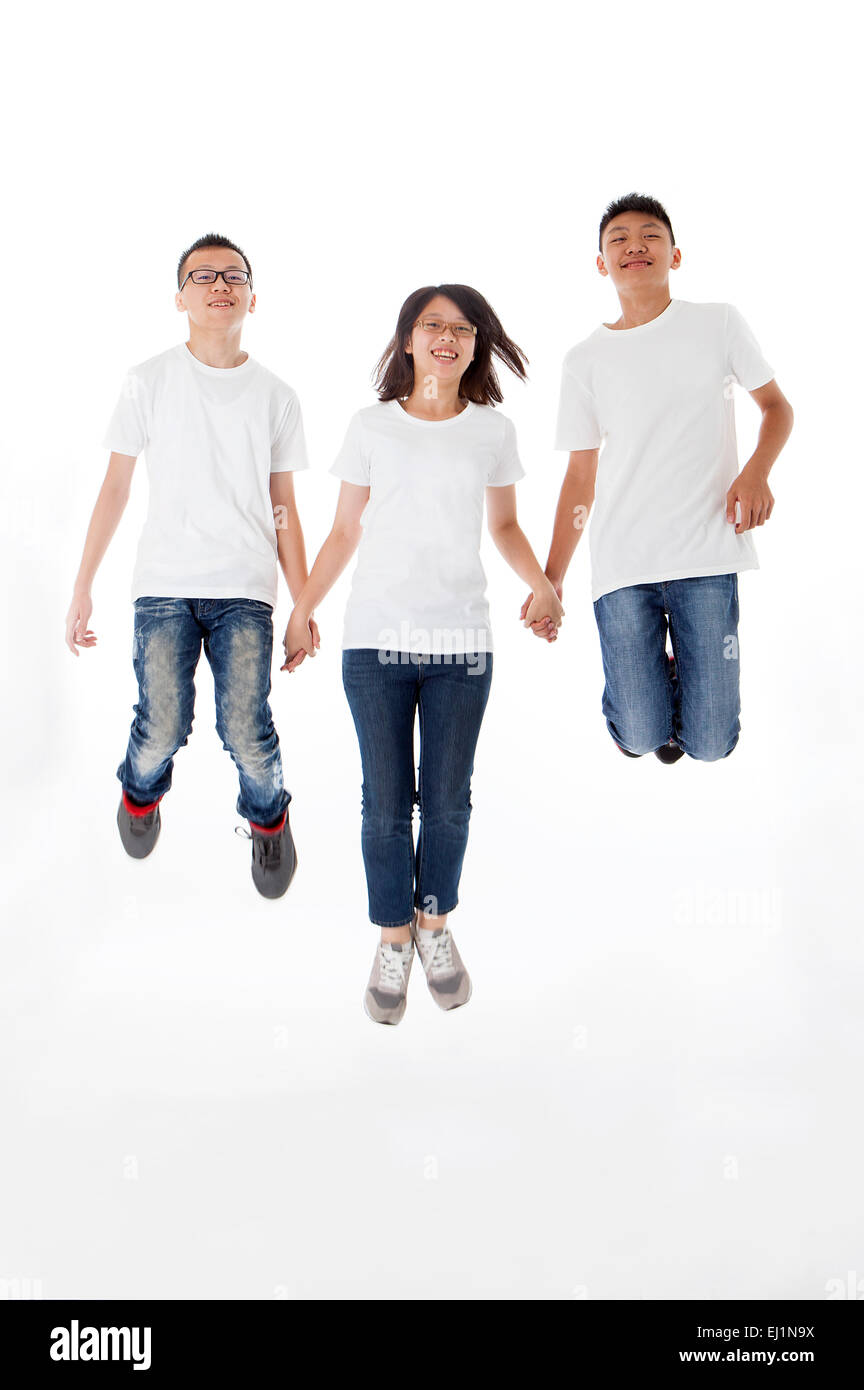 Teenagers jumping in mid-air and holding hands together Stock Photo - Alamy