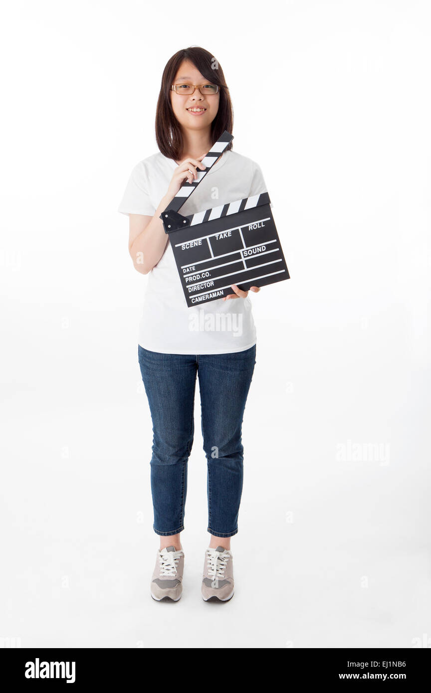 Teenage girl holding film slate and smiling at the camera Stock Photo ...