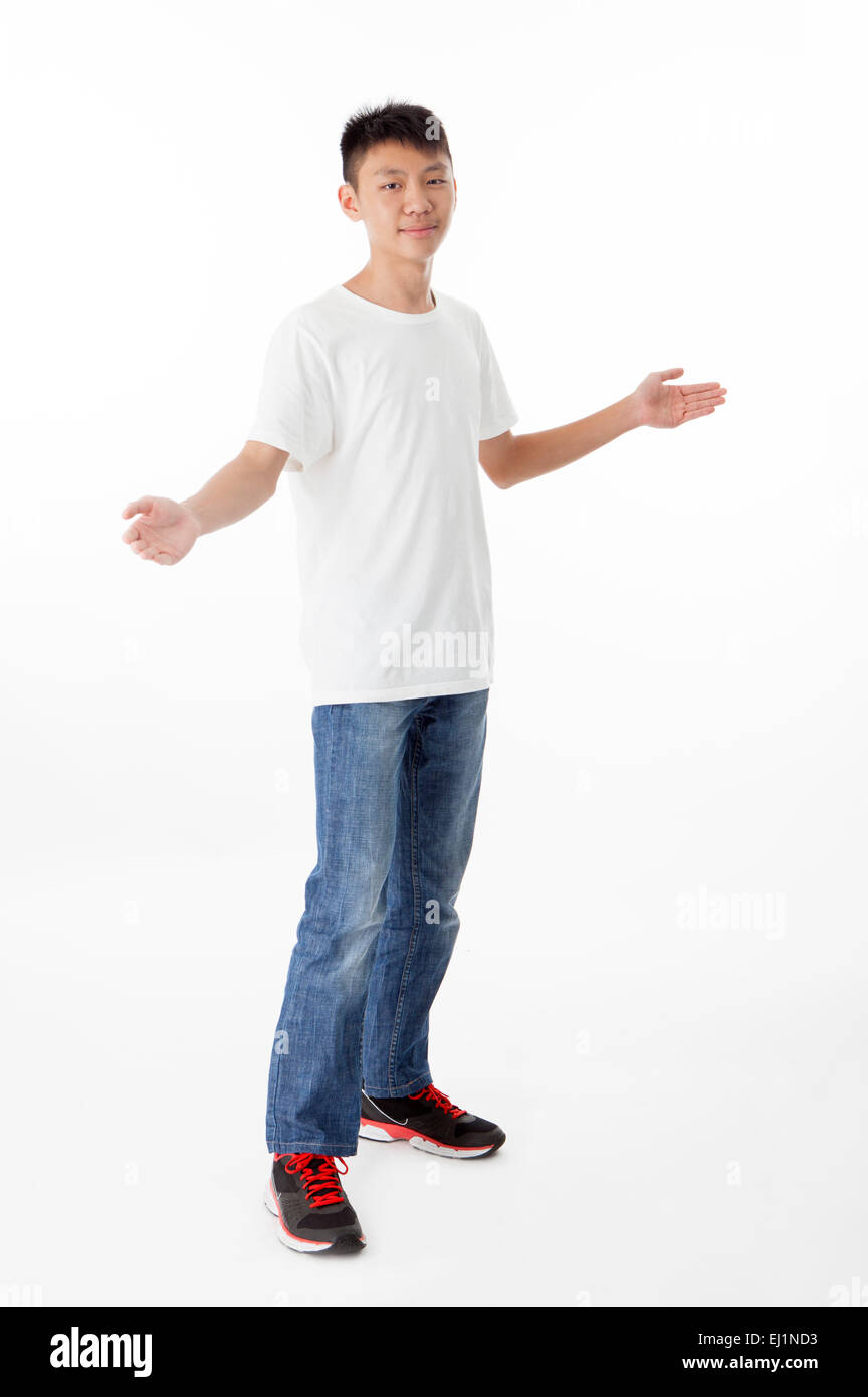 Teenage boy standing with arms outstretched and smiling at the camera ...