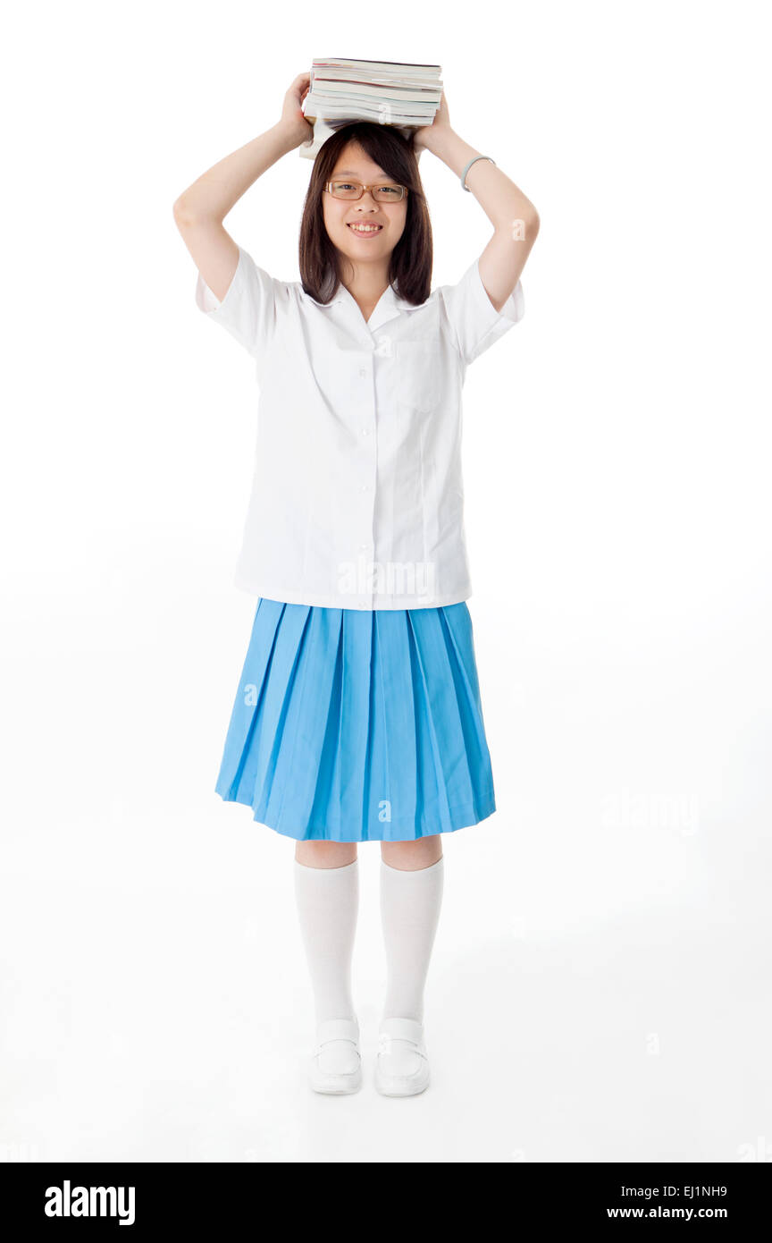 Teenage girl standing and lifting books with smile Stock Photo - Alamy