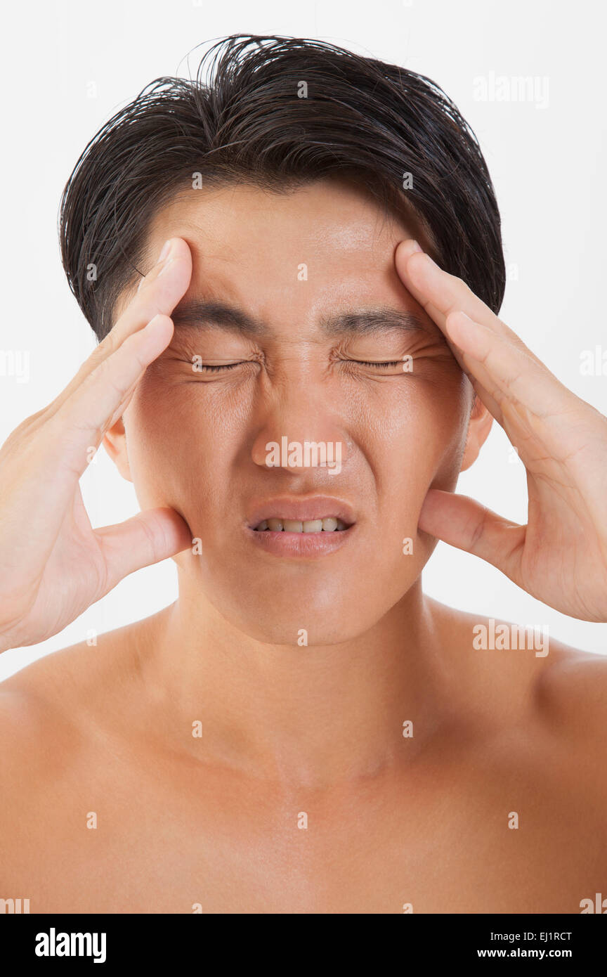 Man closing eyes with hands on face Stock Photo - Alamy