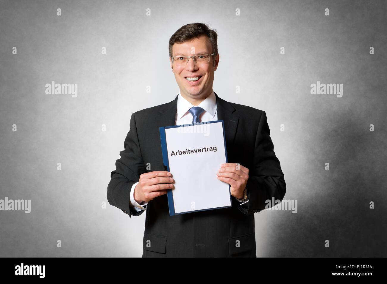 Happy business man with german employment contract Stock Photo - Alamy