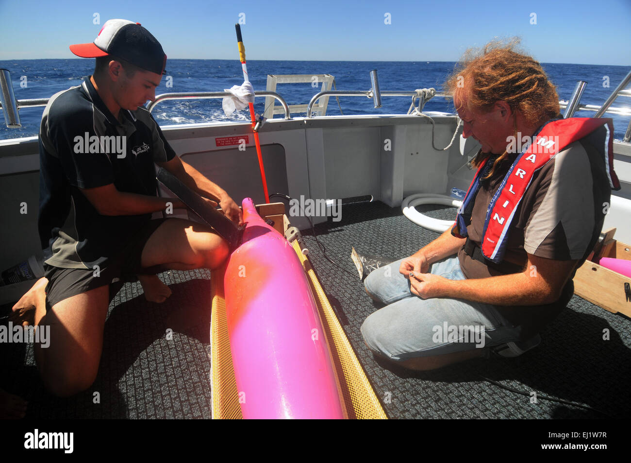 Technicians attaching wings to ocean glider before it gets launched ...