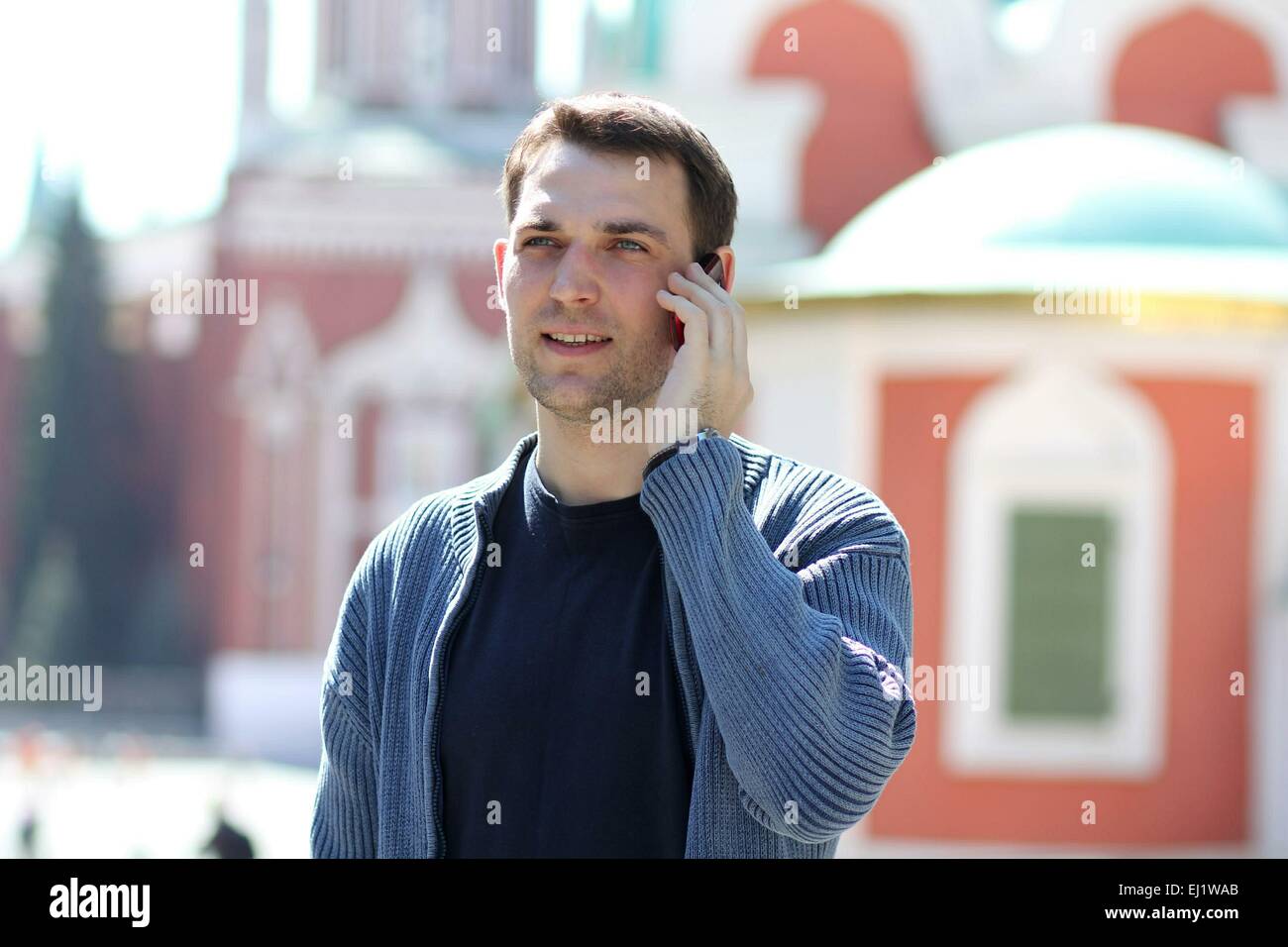 Happy man calling on a phone in summer street. Model Released Stock ...