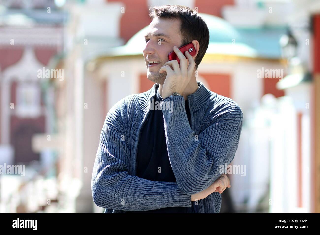 Happy man calling on a phone in summer street. Model Released Stock ...