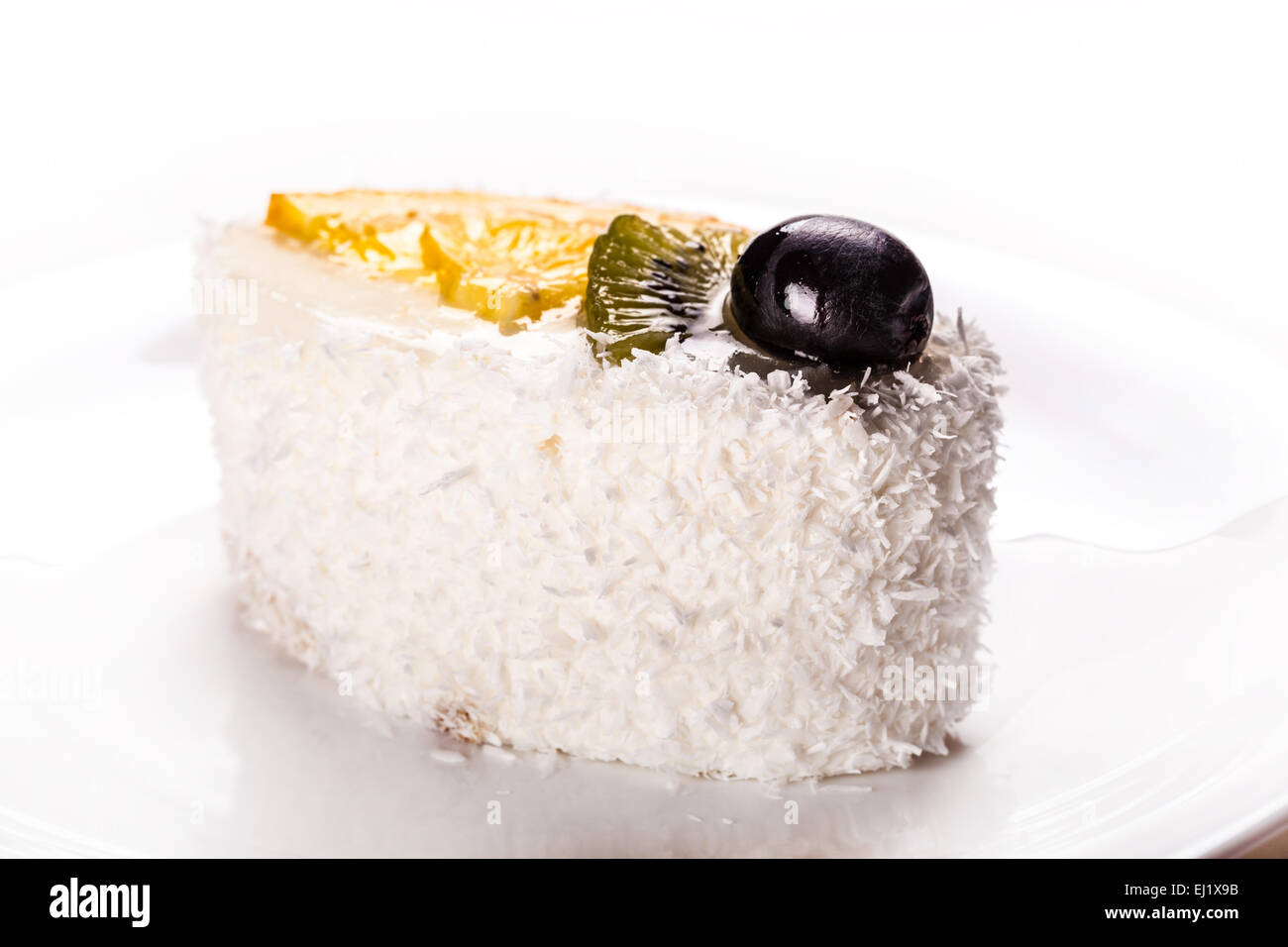 tasty coconut cake slice close-up on a white background Stock Photo - Alamy