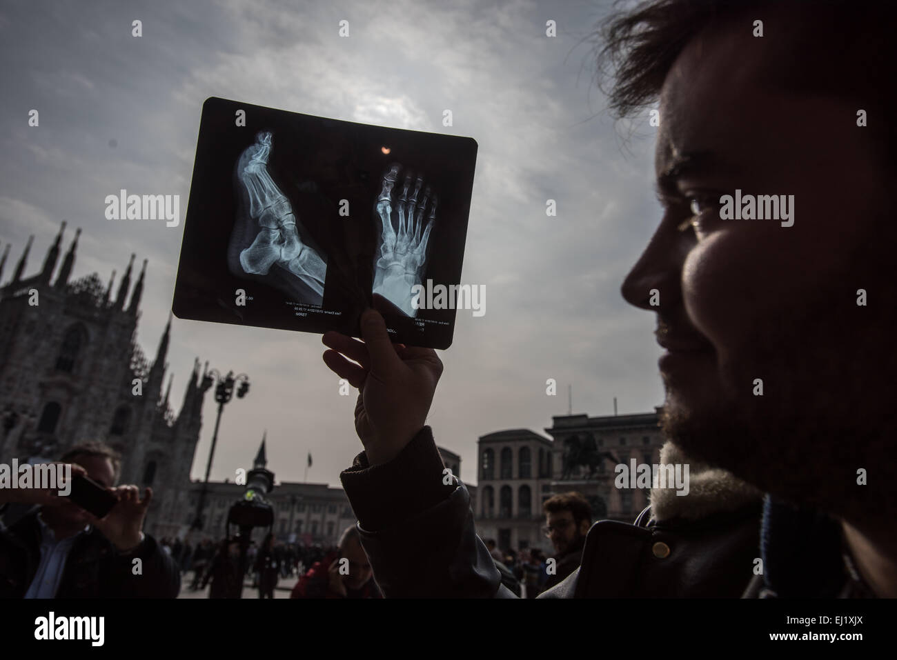 Milan, Italy - 20 March 2015: a man looks at a partial solar eclipse ...