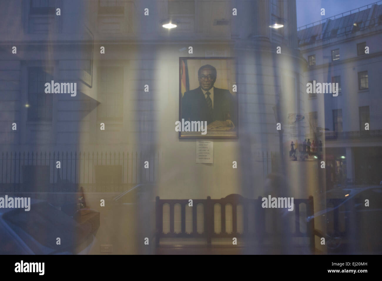 Framed portrait of Zimbabwe President Robert Mugabe through window of ...