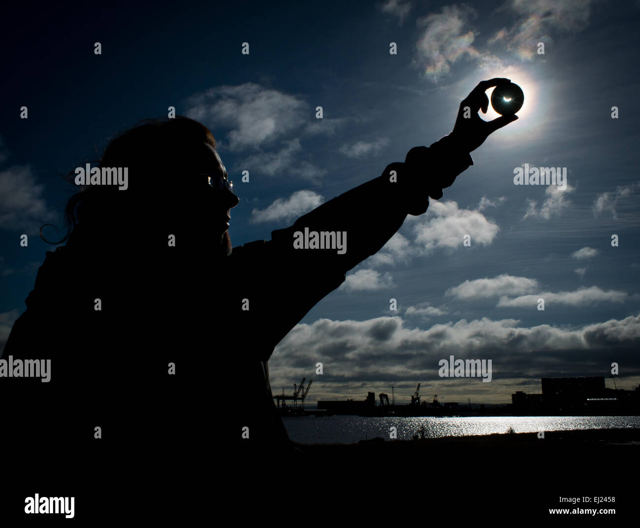 A lady holds a filter in front of the partial solar eclipse, Leith ...