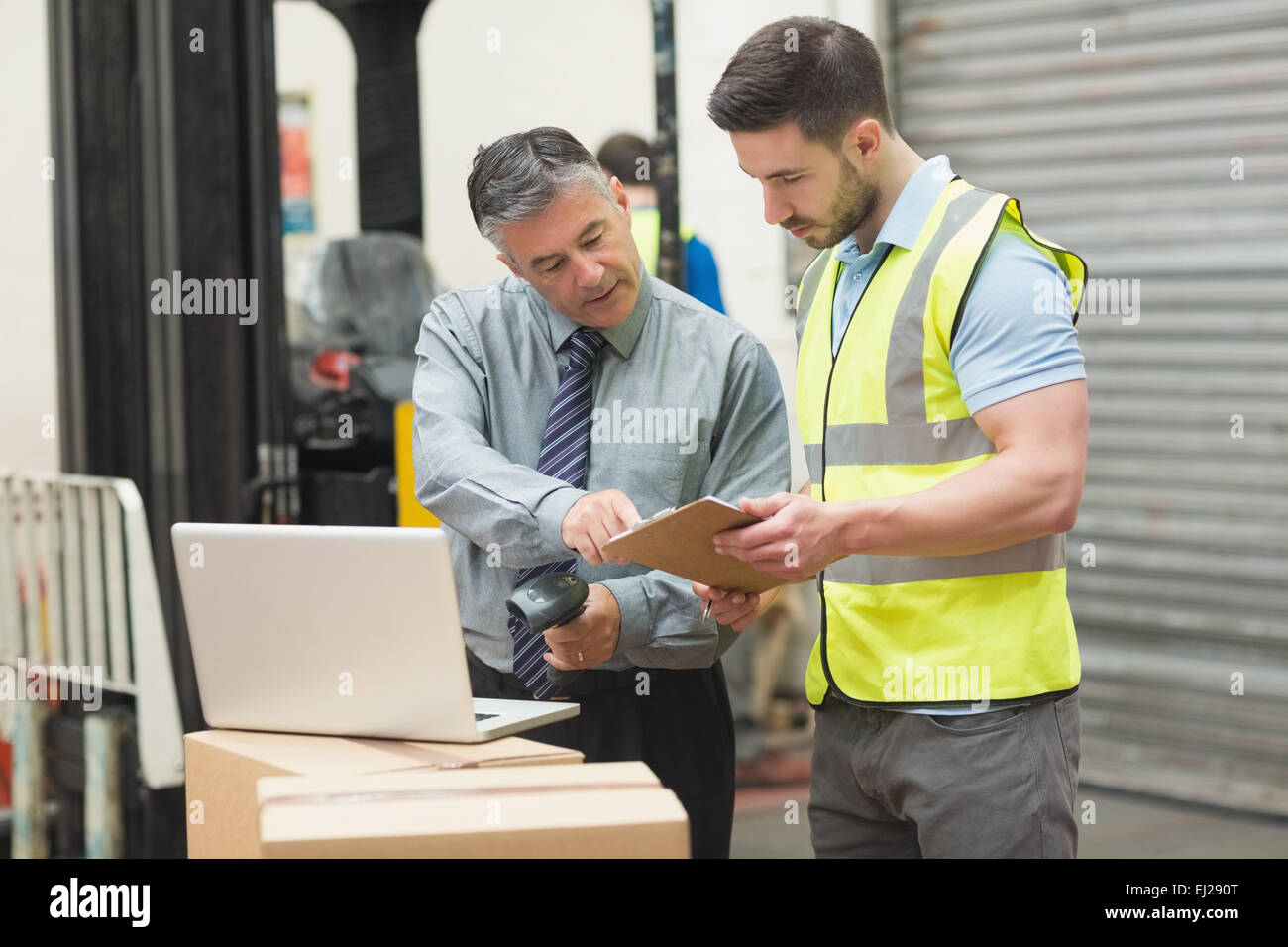 Workers scanning package in warehouse Stock Photo - Alamy