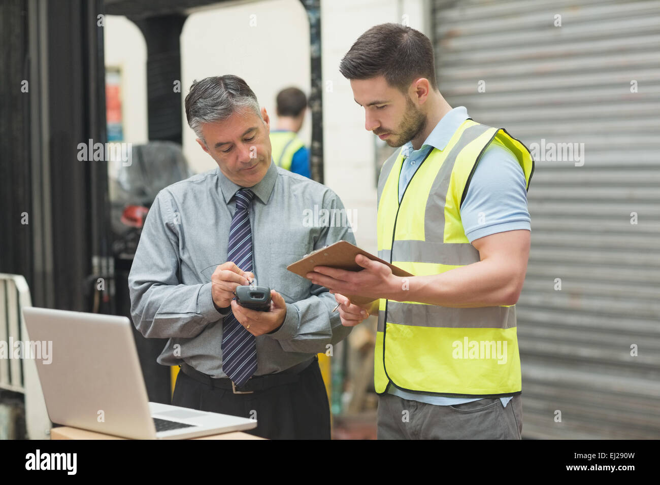 Workers scanning package in warehouse Stock Photo - Alamy