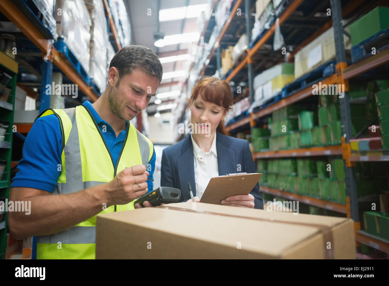 Worker and manager scanning package in warehouse Stock Photo - Alamy