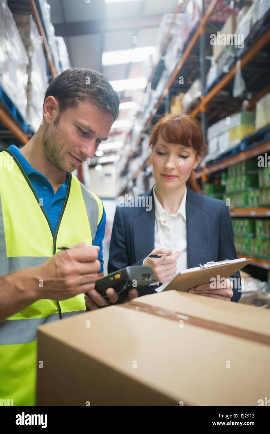 Worker and manager scanning package in warehouse Stock Photo - Alamy