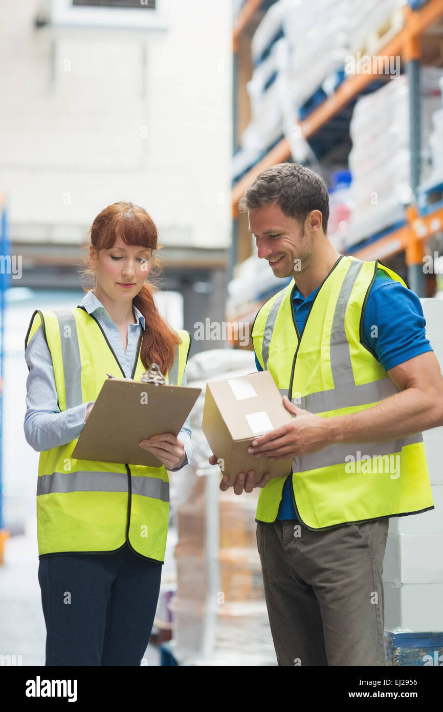 Smiling warehouse manager and delivery man Stock Photo - Alamy