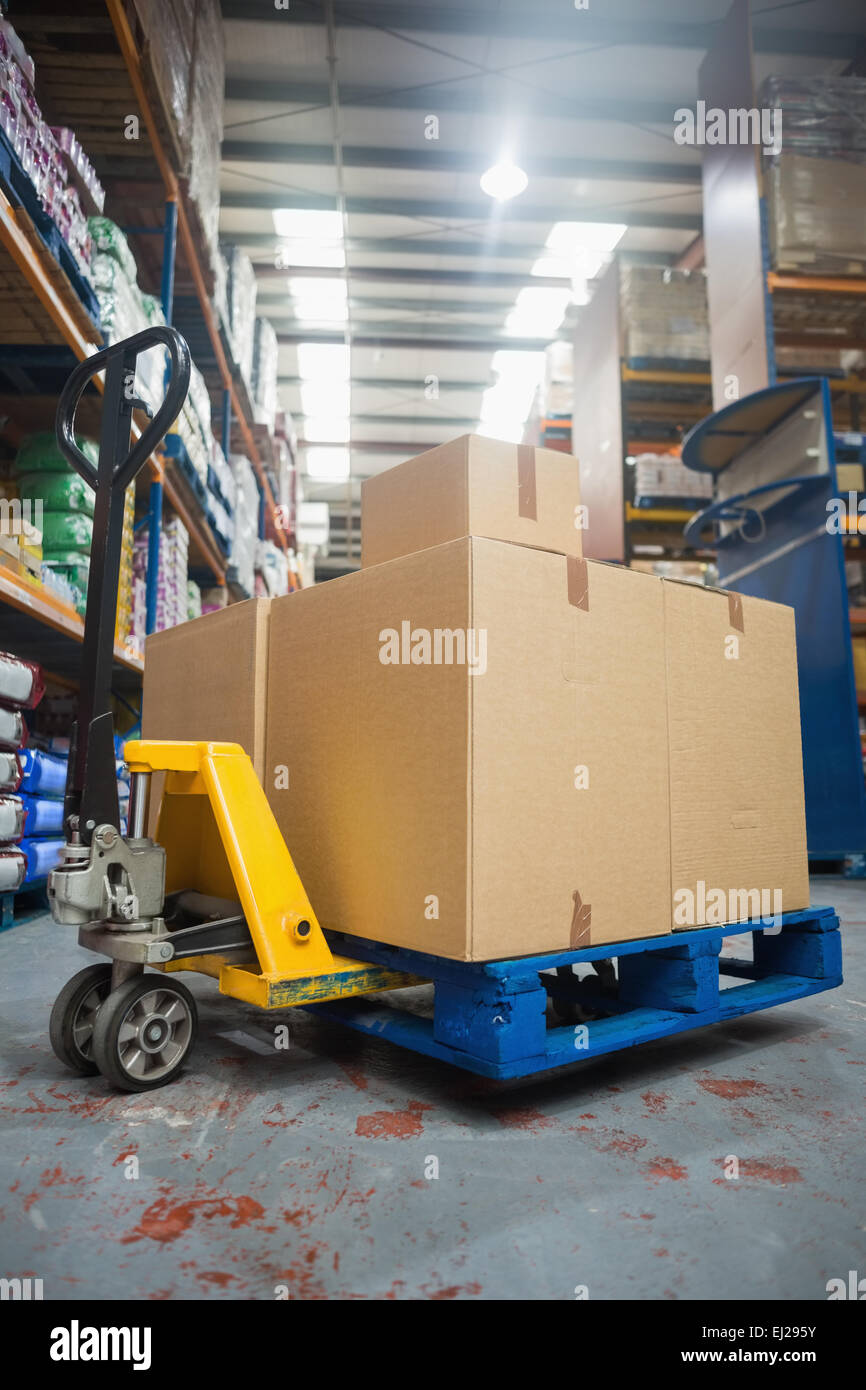 Boxes on trolley in warehouse Stock Photo - Alamy