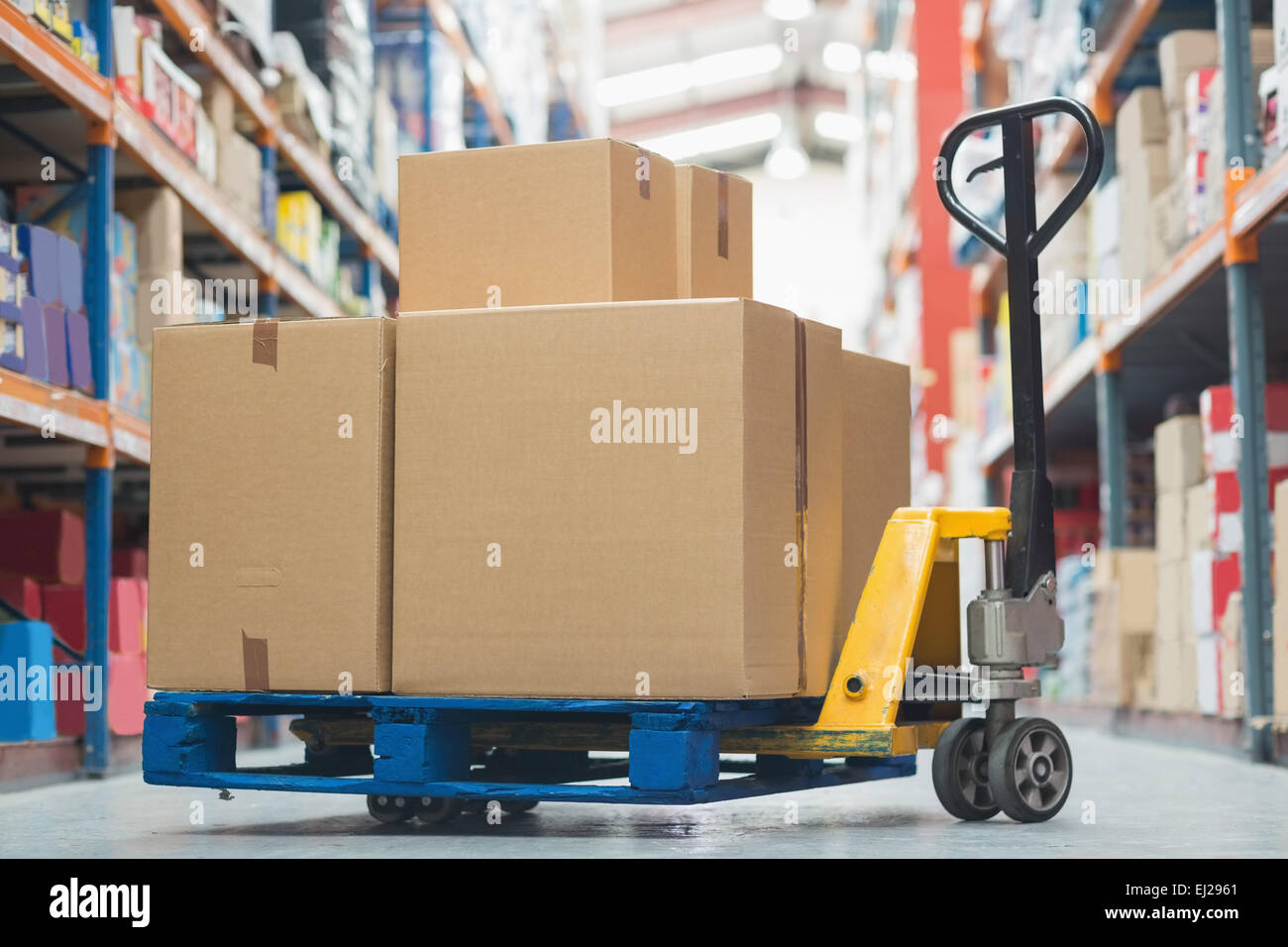 Boxes on trolley in warehouse Stock Photo - Alamy