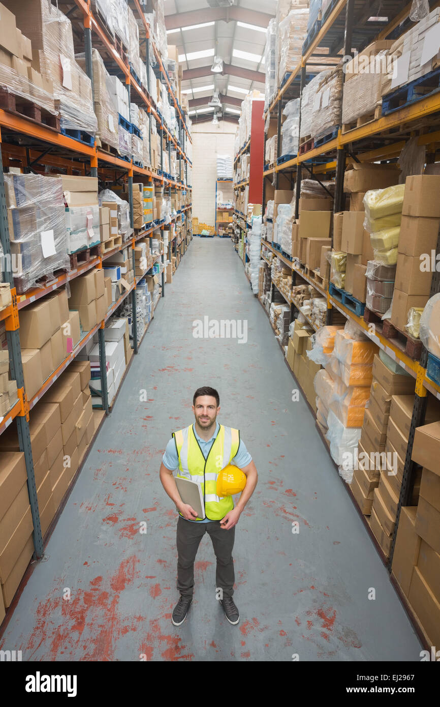 Worker holding hard hat and clipboard Stock Photo - Alamy