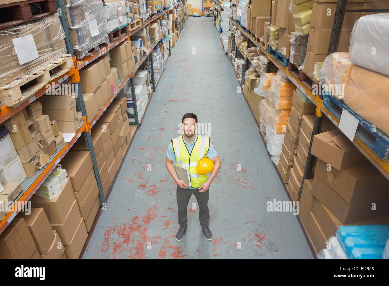 Worker holding hard hat and clipboard Stock Photo - Alamy