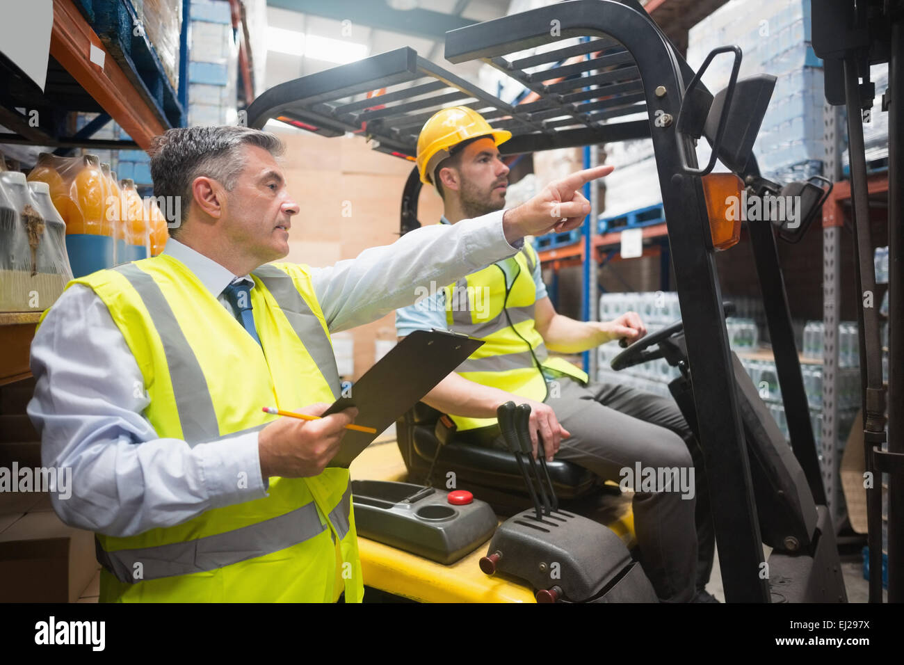 Forklift driver talking with his manager Stock Photo - Alamy