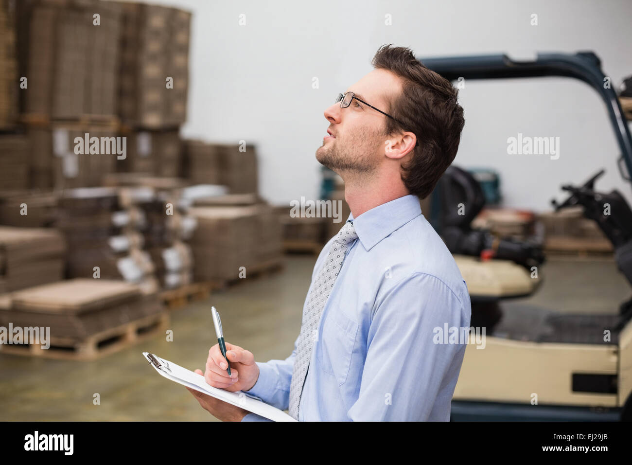 Warehouse manager checking his inventory Stock Photo - Alamy