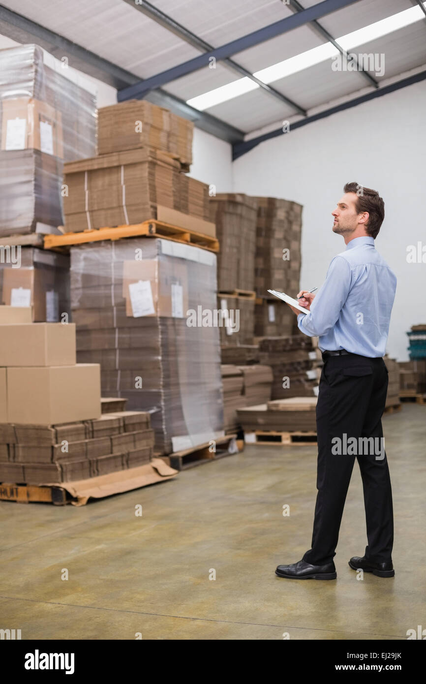 Warehouse manager checking his inventory Stock Photo - Alamy