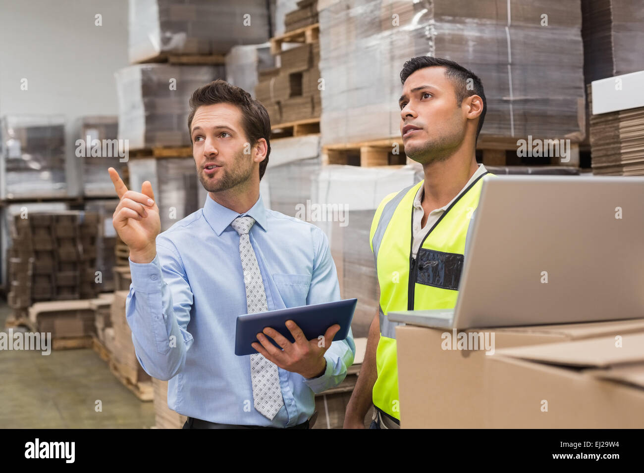 Warehouse worker and manager working together Stock Photo - Alamy