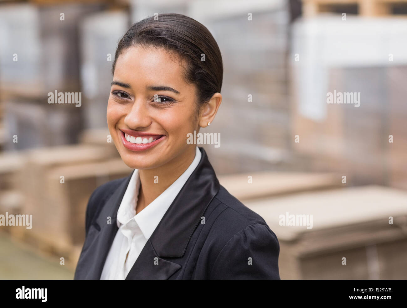 Warehouse manager smiling at camera Stock Photo - Alamy