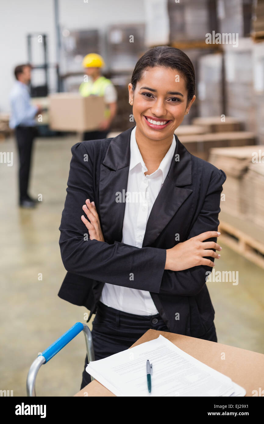Female manager with arms crossed in warehouse Stock Photo - Alamy