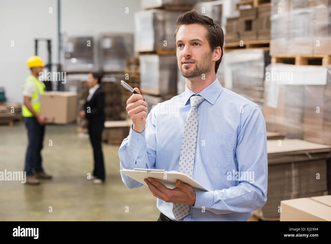Warehouse manager checking his inventory Stock Photo - Alamy
