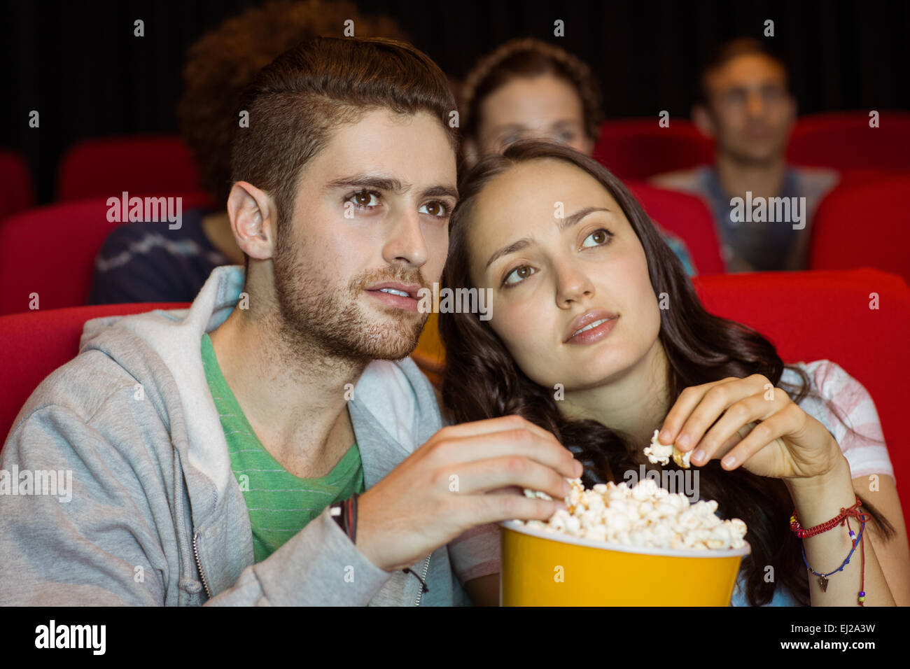 Young couple watching a film Stock Photo - Alamy
