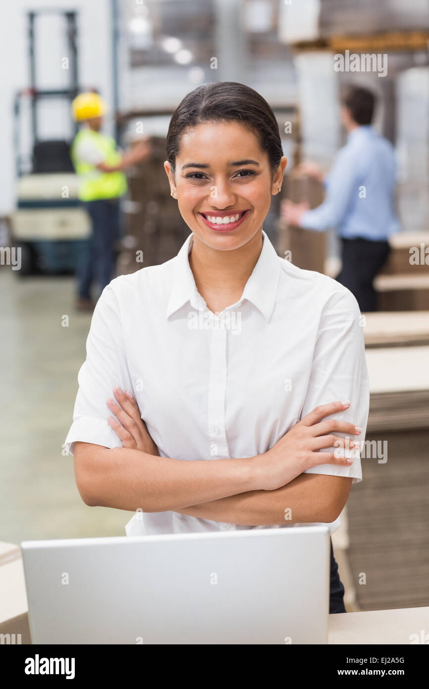 Female manager with arms crossed in warehouse Stock Photo - Alamy