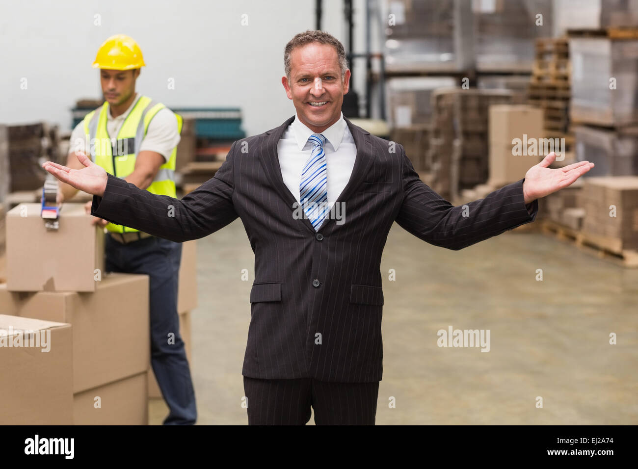 Smiling boss with hands out Stock Photo - Alamy