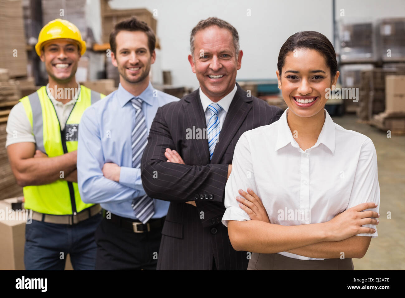 Warehouse team smiling at camera Stock Photo - Alamy