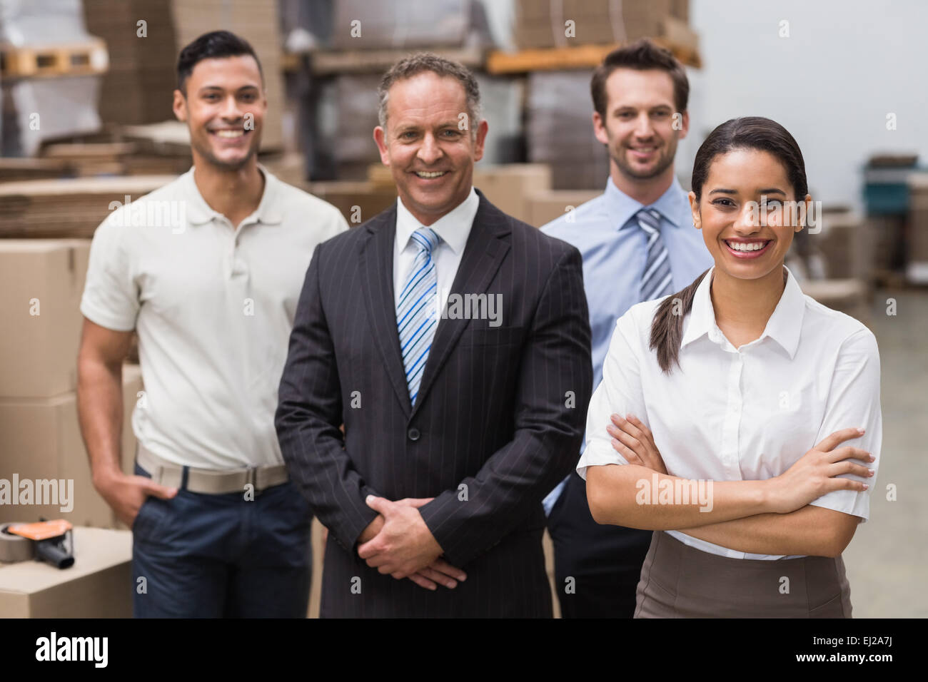 Warehouse team smiling at camera Stock Photo - Alamy