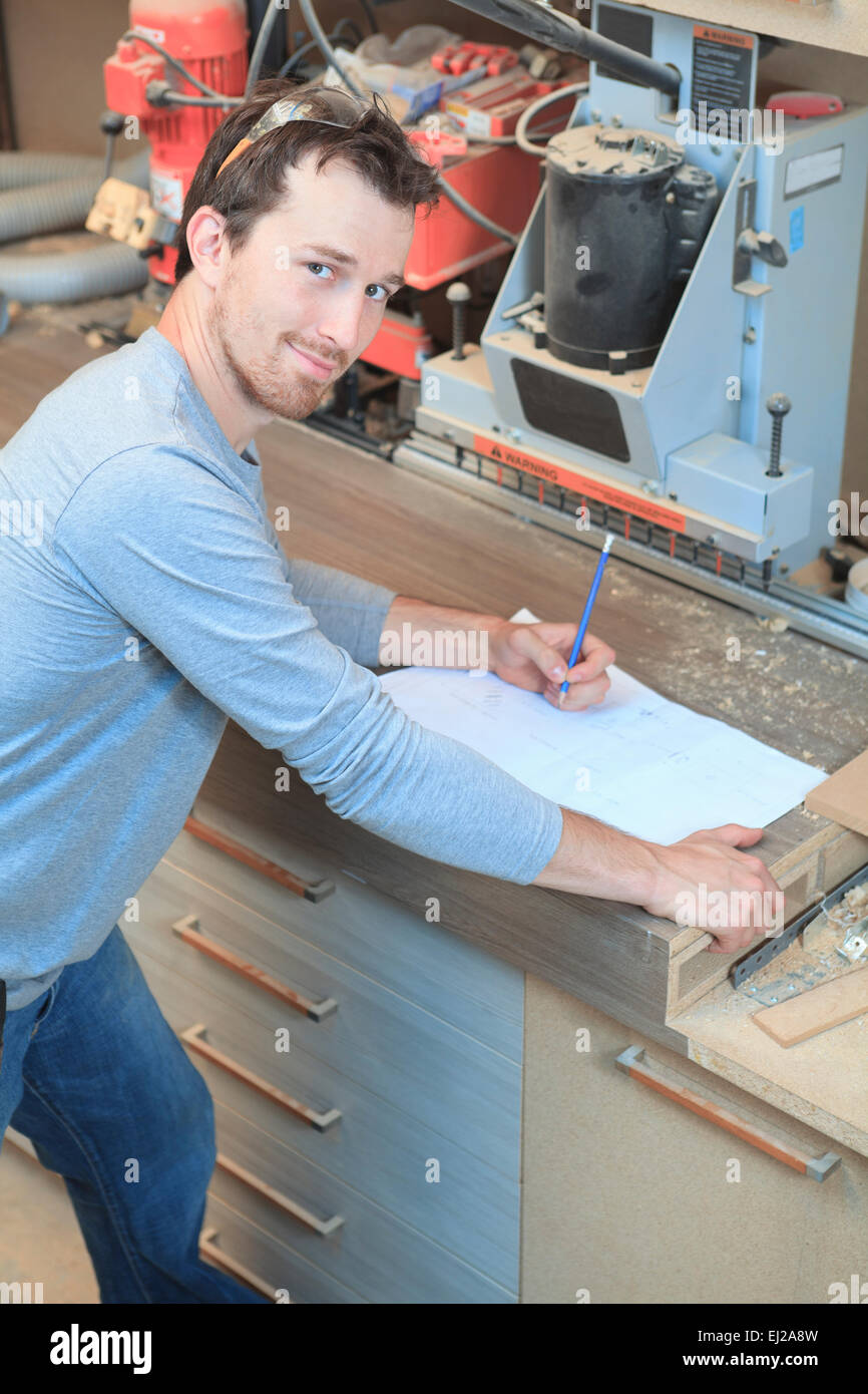 carpenter at draw table in workshop Stock Photo - Alamy