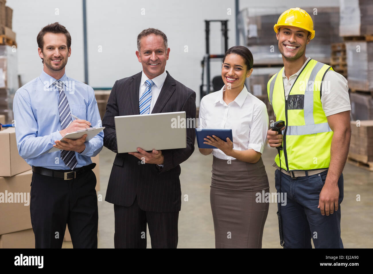 Smiling warehouse team working together Stock Photo - Alamy