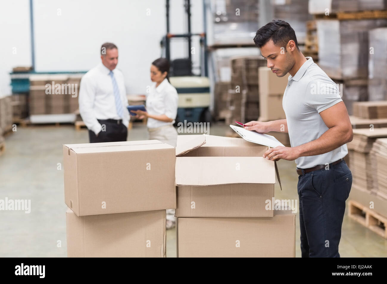 Warehouse manager checking his inventory Stock Photo - Alamy