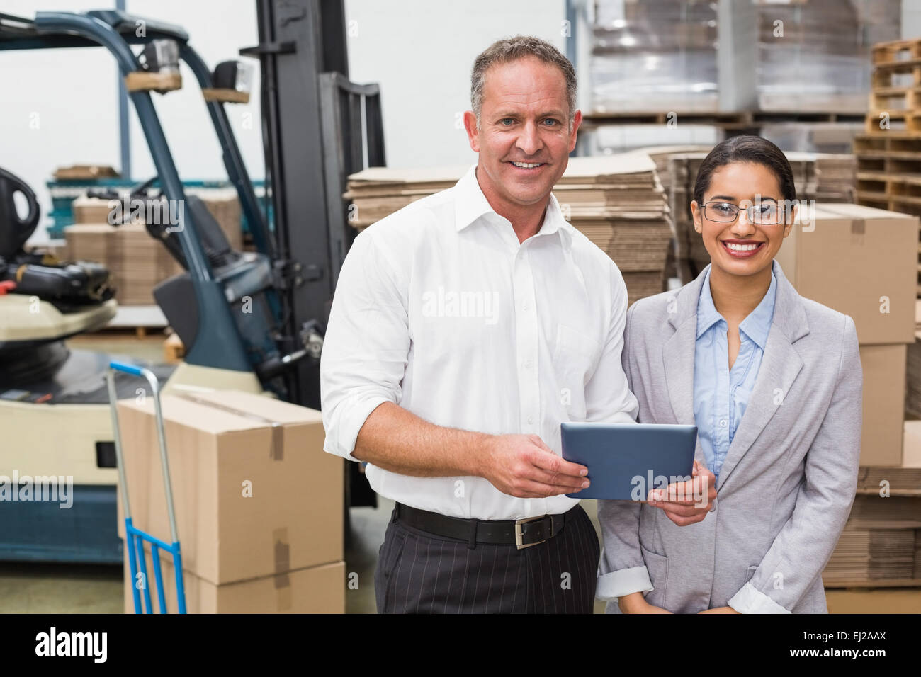Warehouse manager and her boss working together Stock Photo - Alamy