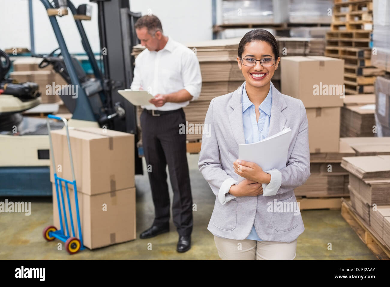 Female manager holding files during busy period Stock Photo - Alamy