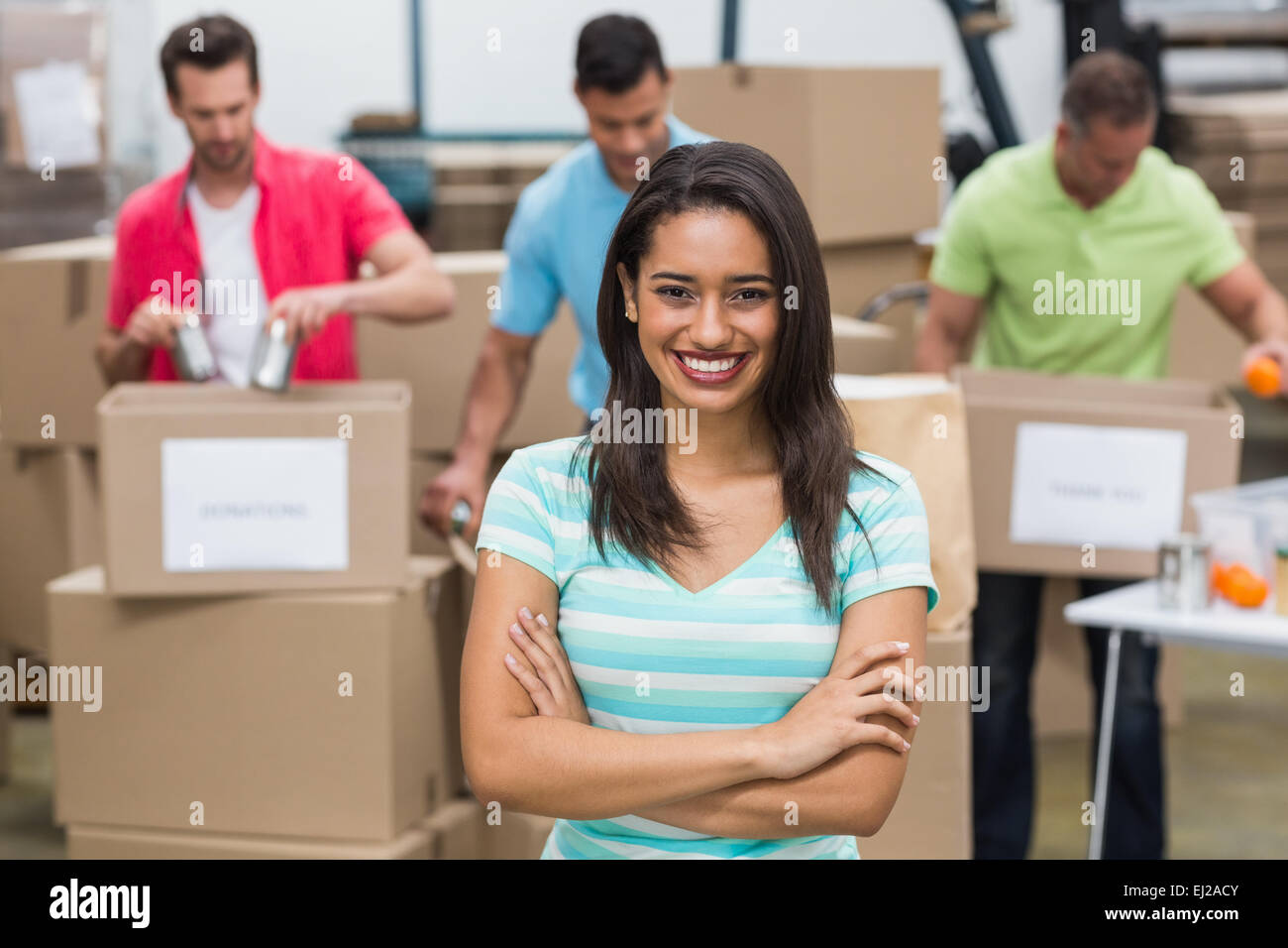 Portrait of a smiling volunteer with arms crossed Stock Photo - Alamy
