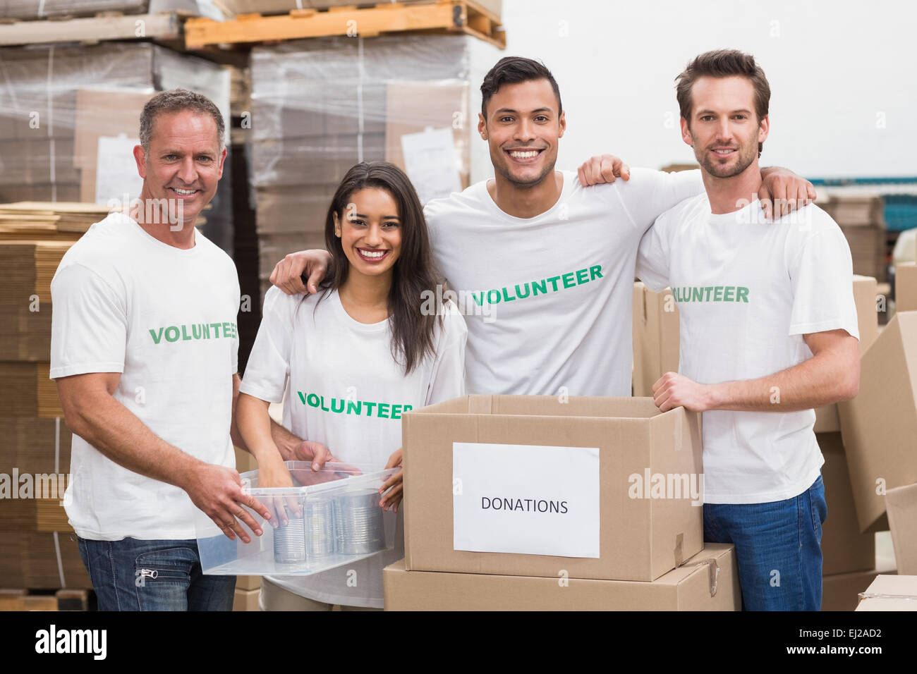Team of volunteers smiling at camera Stock Photo - Alamy