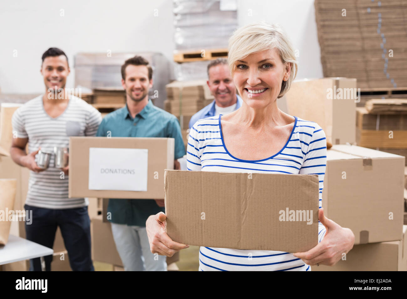 Smiling volunteer showing a poster Stock Photo - Alamy