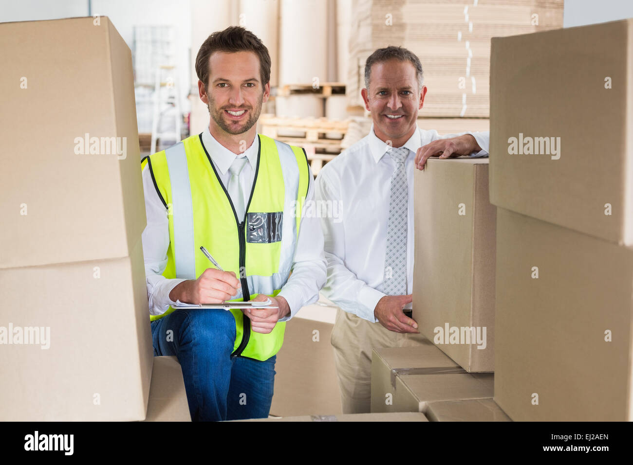 Delivery driver checking his list on clipboard Stock Photo - Alamy