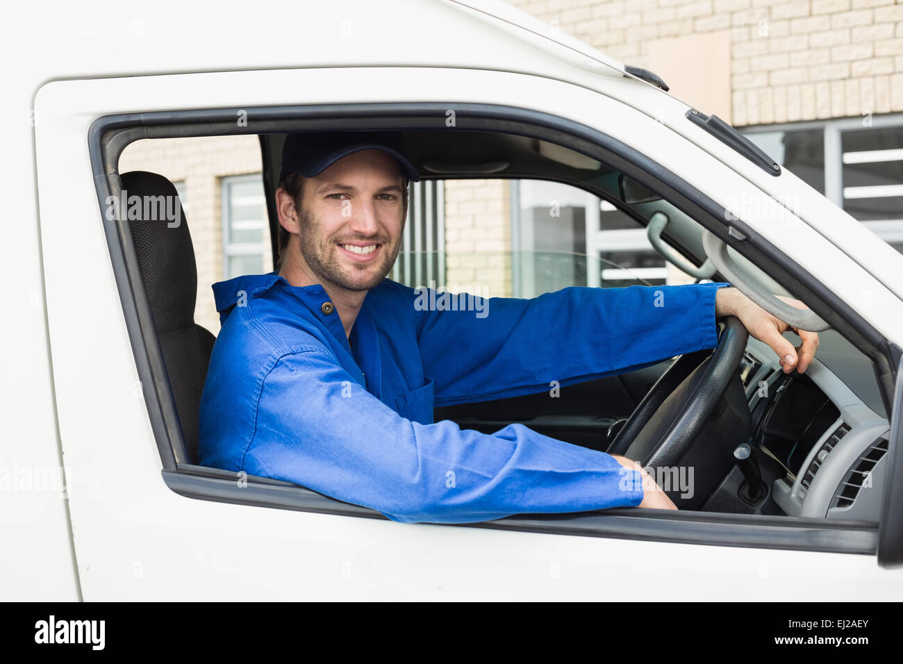 Cheerful courier smiling camera hi-res stock photography and images - Alamy