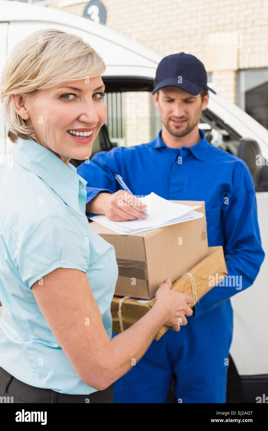 Happy delivery man with customer Stock Photo - Alamy