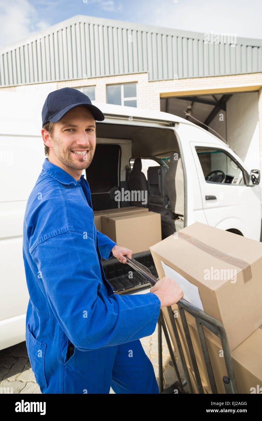 Delivery driver packing his van Stock Photo - Alamy