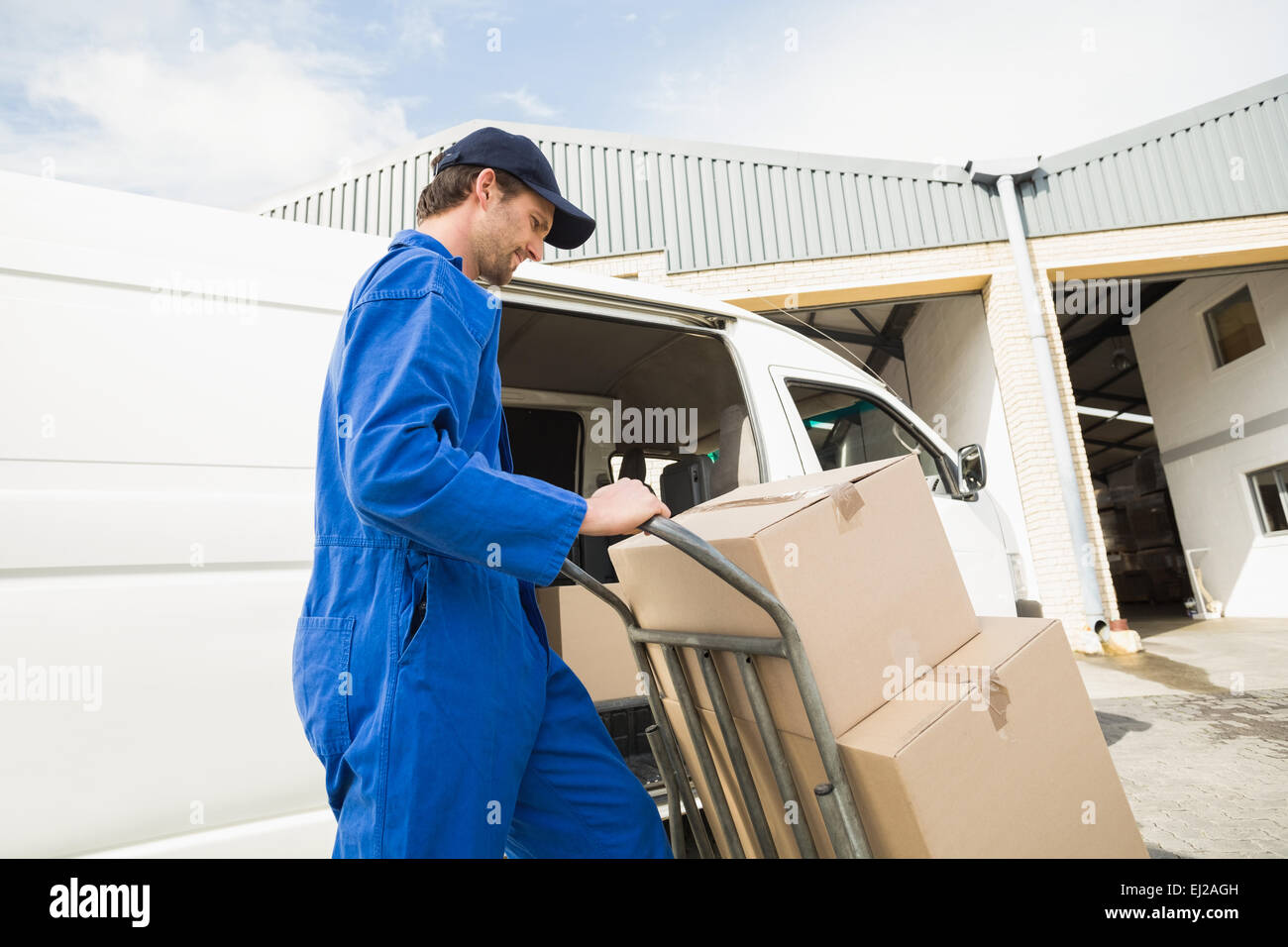 Delivery driver packing his van Stock Photo - Alamy