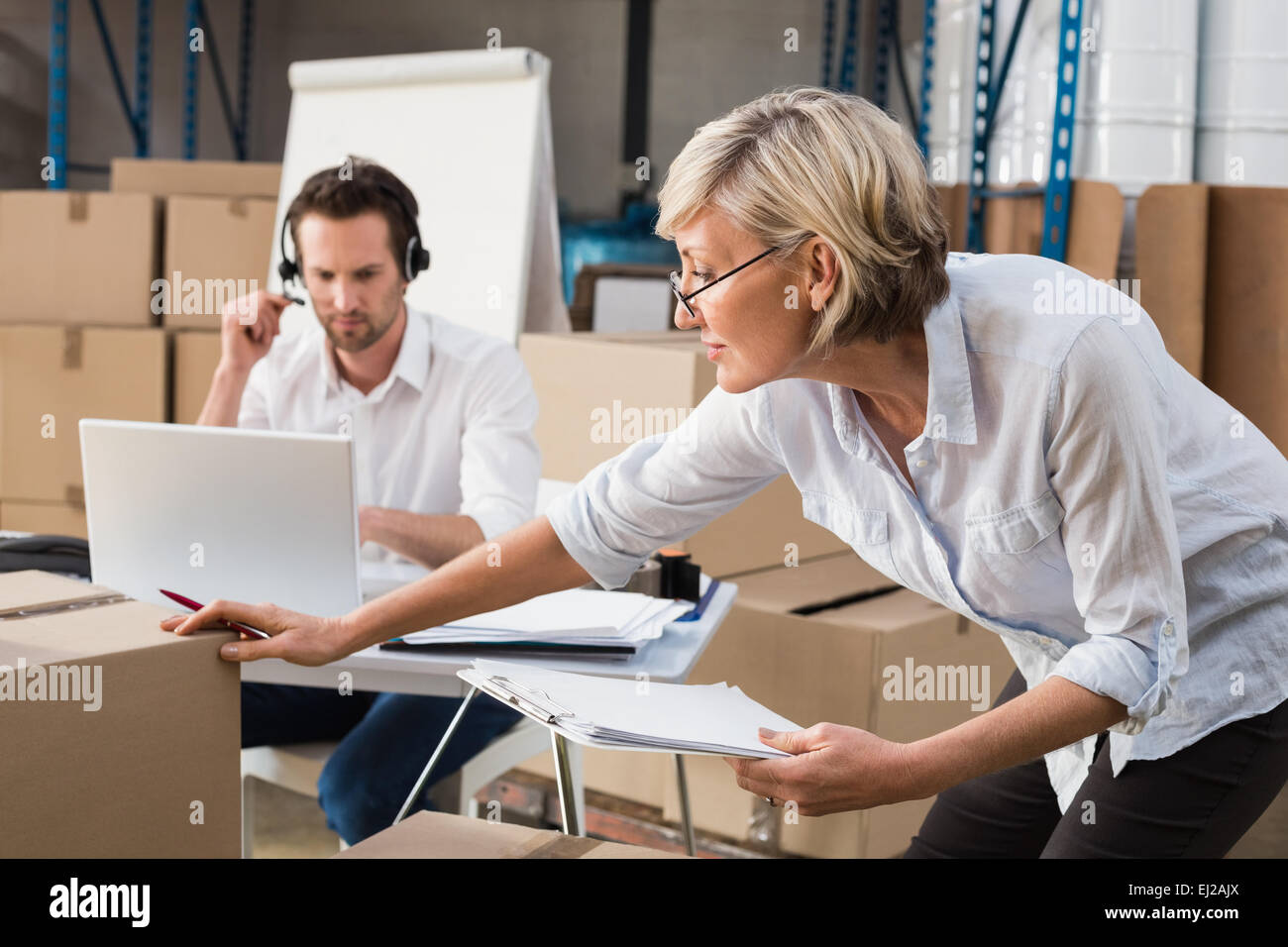 Warehouse manager checking her inventory Stock Photo - Alamy