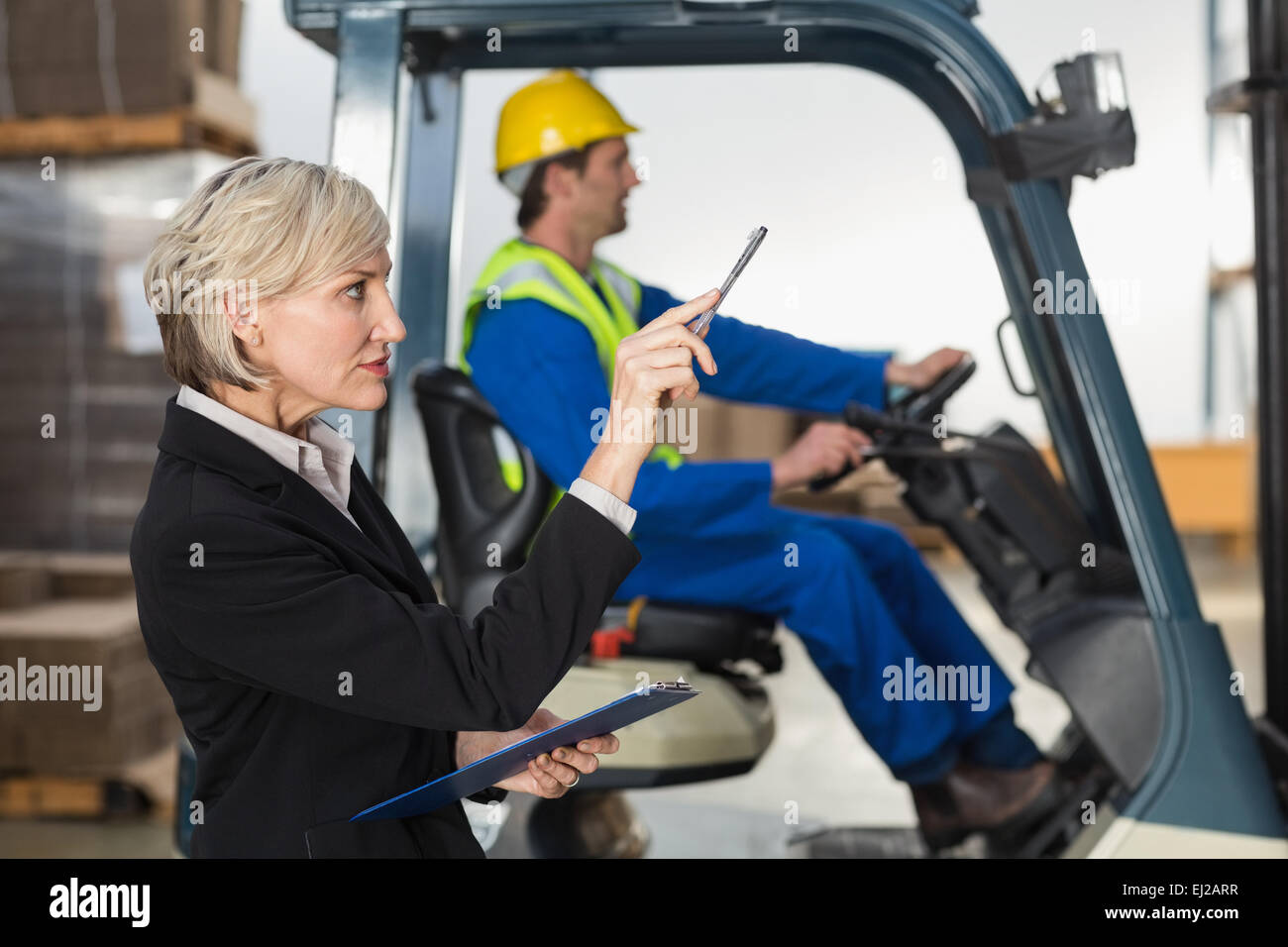 Warehouse manager checking her inventory Stock Photo - Alamy